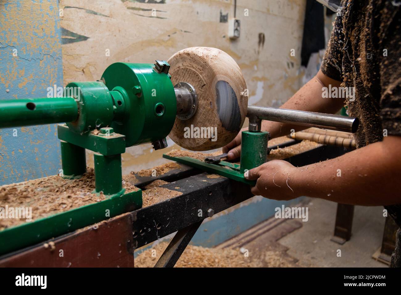 Carpenter preparing machine for turning wood on a lathe Stock Photo - Alamy