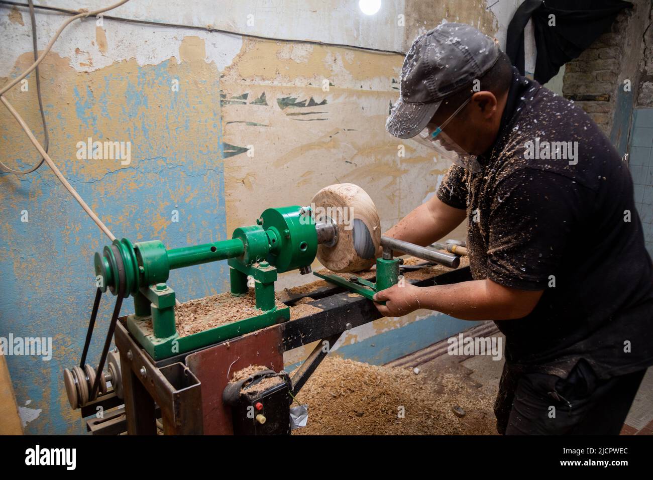 Carpenter preparing machine for turning wood on a lathe Stock Photo - Alamy
