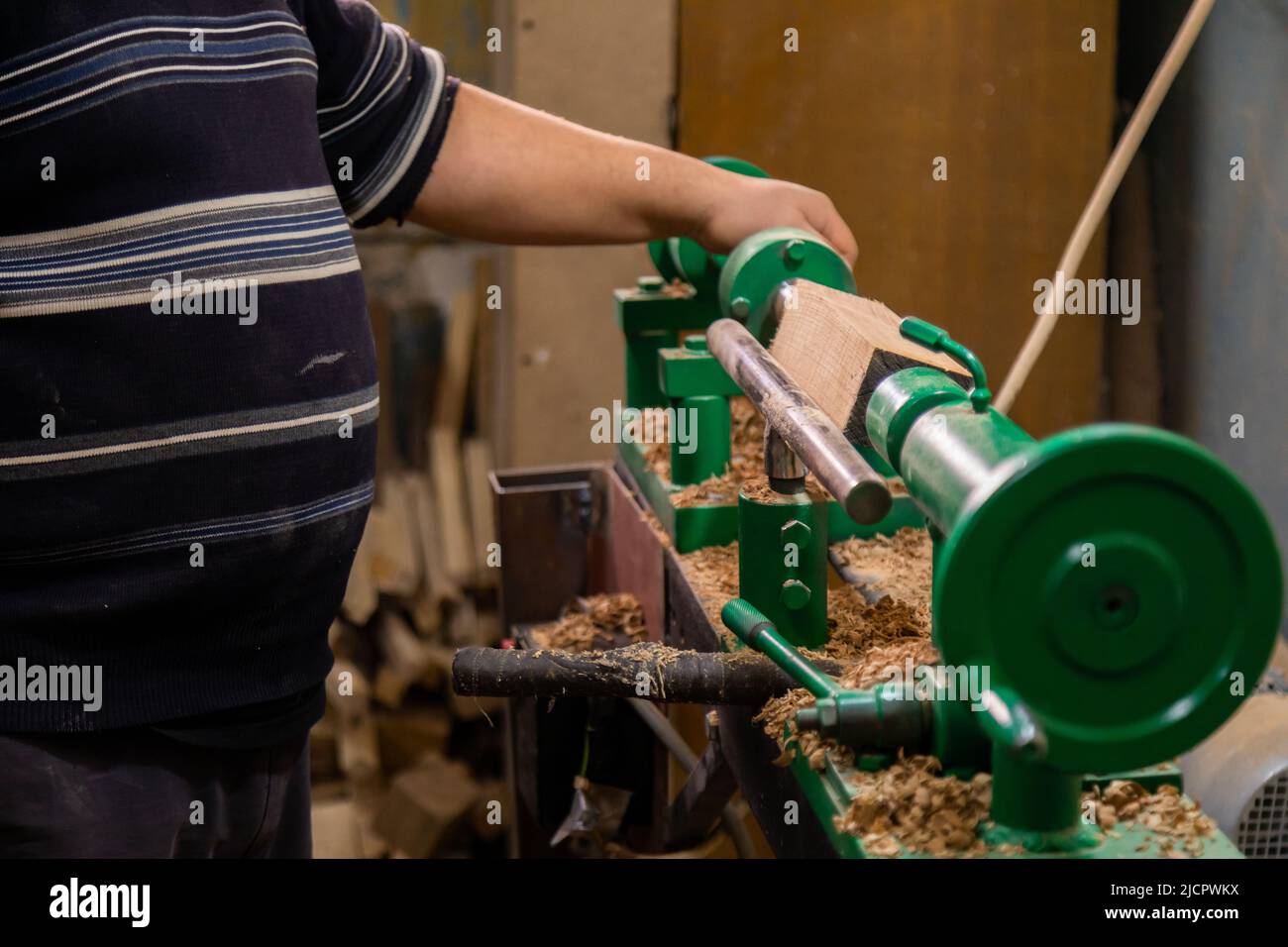 Carpenter preparing machine for turning wood on a lathe Stock Photo - Alamy