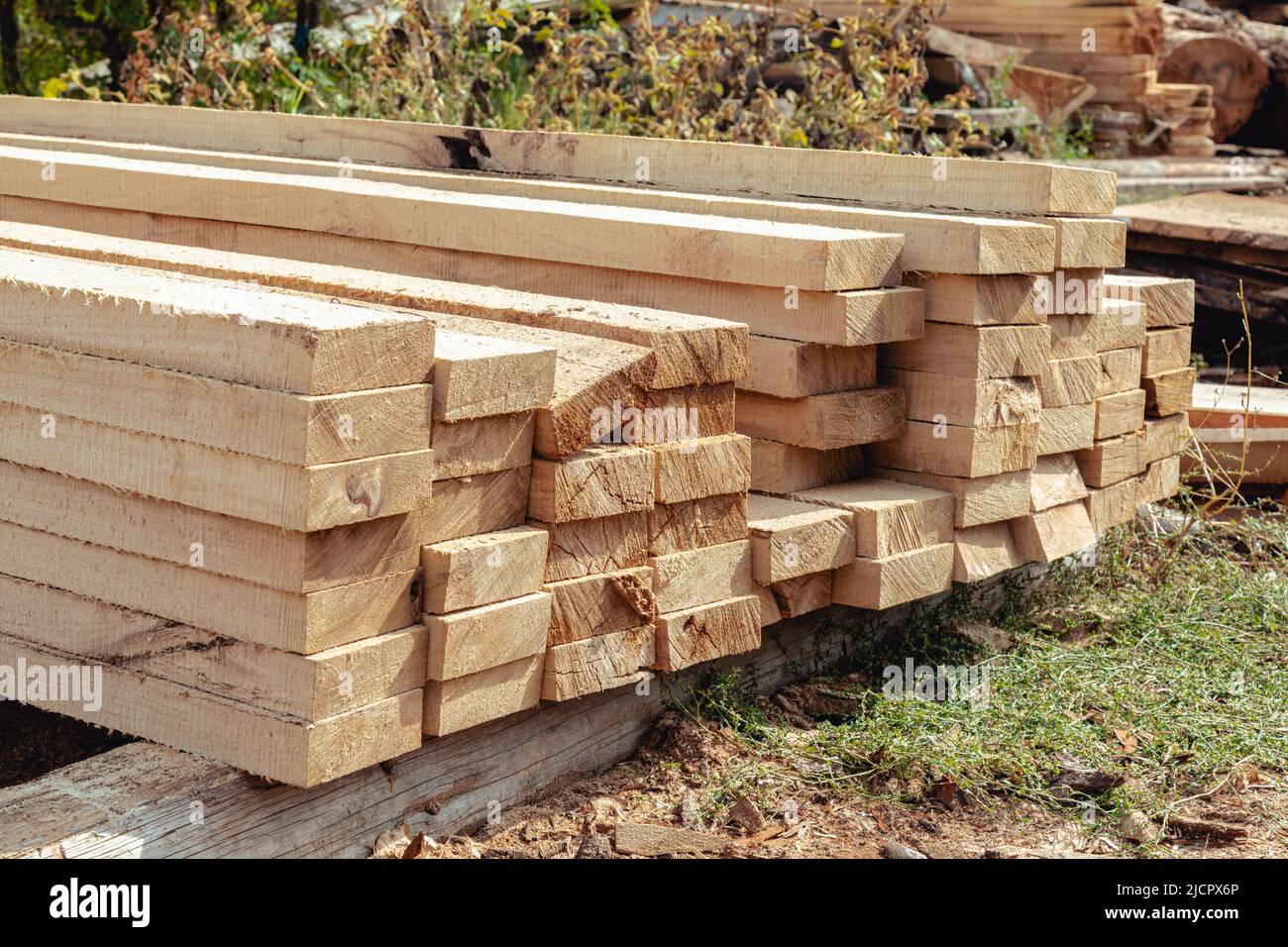 Stacked lumber. Folded wood.Closeup wooden boards. Wood planks stacked ...