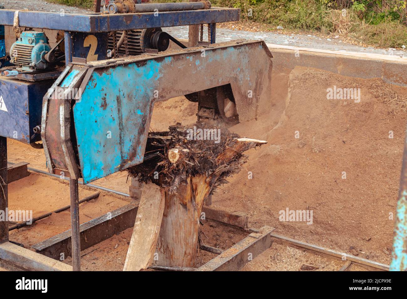Sawing machine cutting tree log at wood production factory. Timber ...