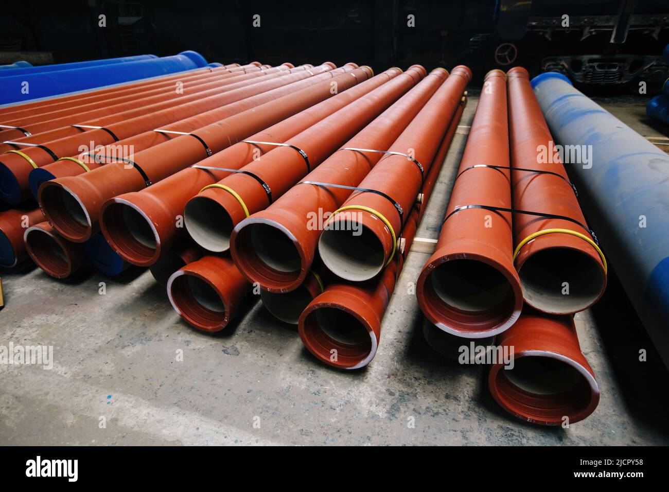 New cast iron pipes for pipeline construction in warehouse Stock Photo ...