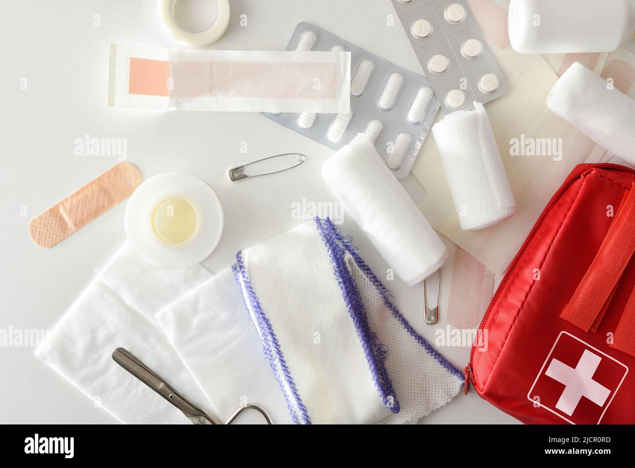 Assortment of emergency first aid kit on white table. Horizontal ...