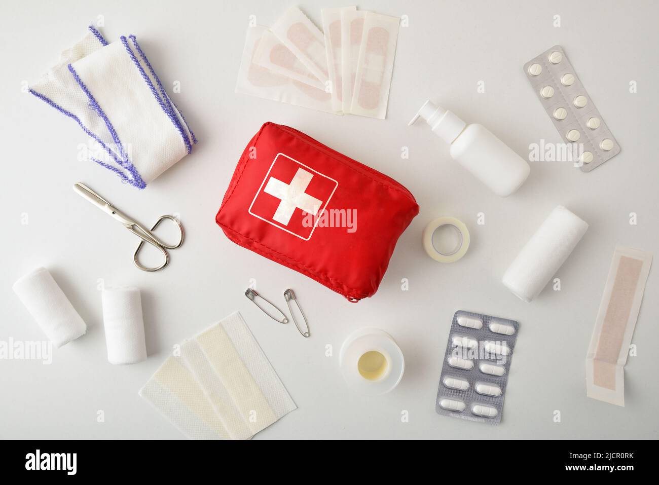 Assortment of emergency first aid kit on white table. Horizontal ...