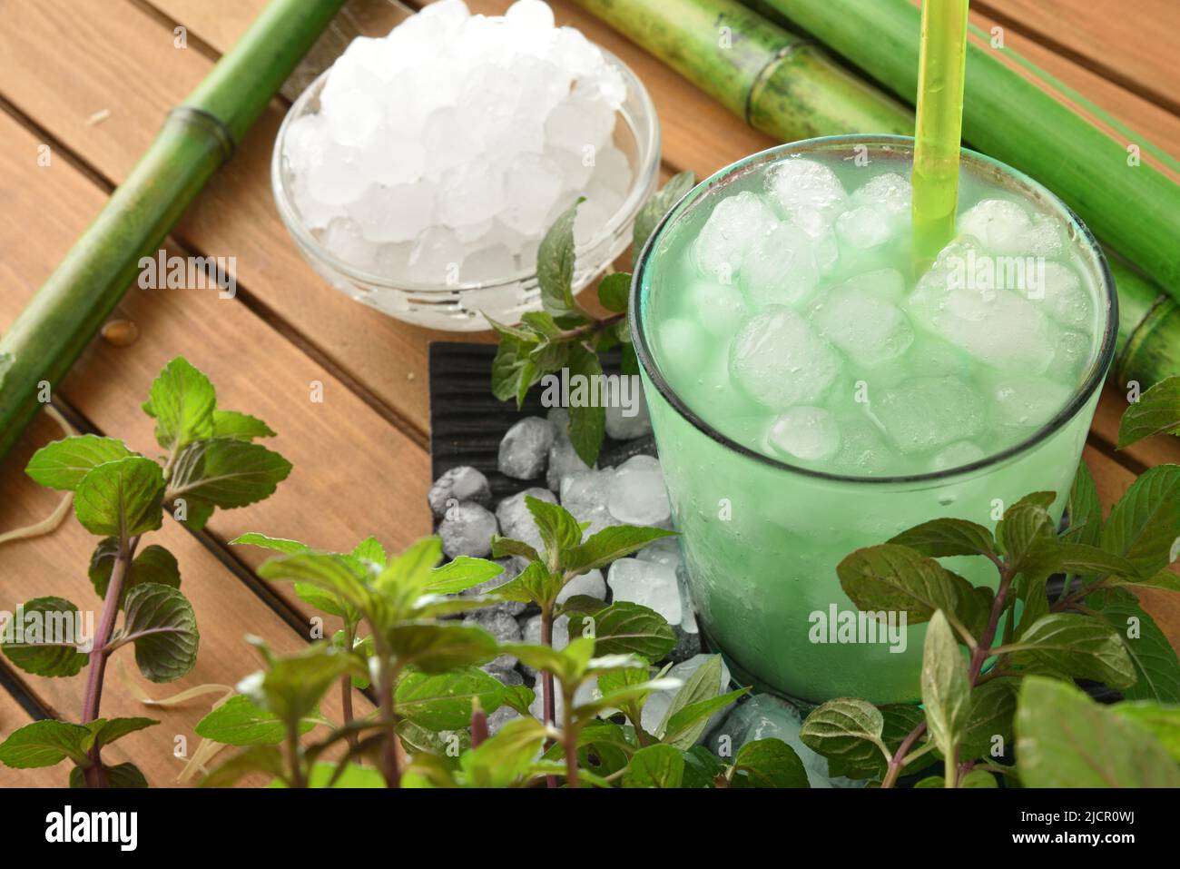 Natural iced mint on wooden table with crushed ice with leaves and ...