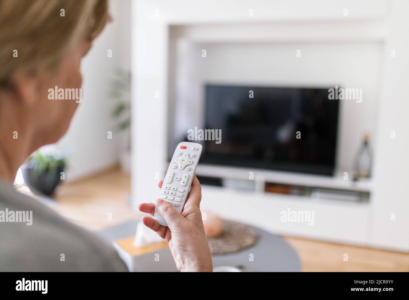 Old woman watching tv hi-res stock photography and images - Alamy