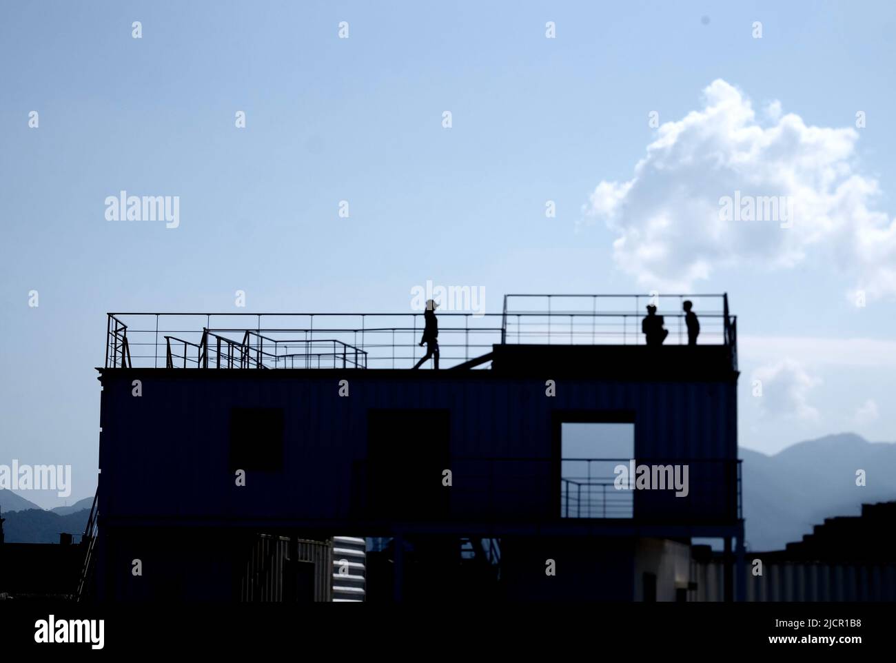 silhouette of people standing on rooftop Stock Photo - Alamy