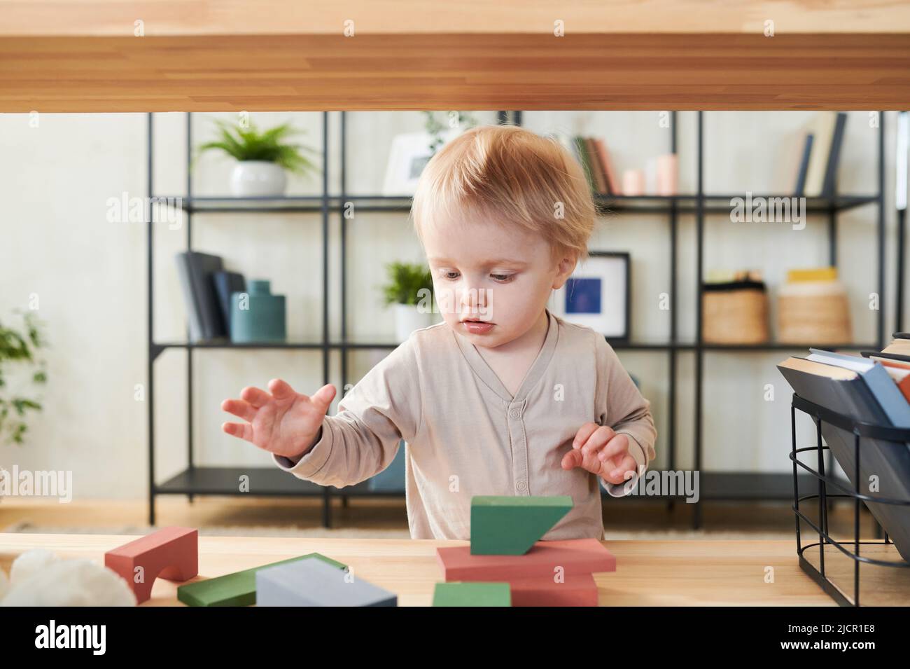 Little child building a tower from colorful constructor during his ...