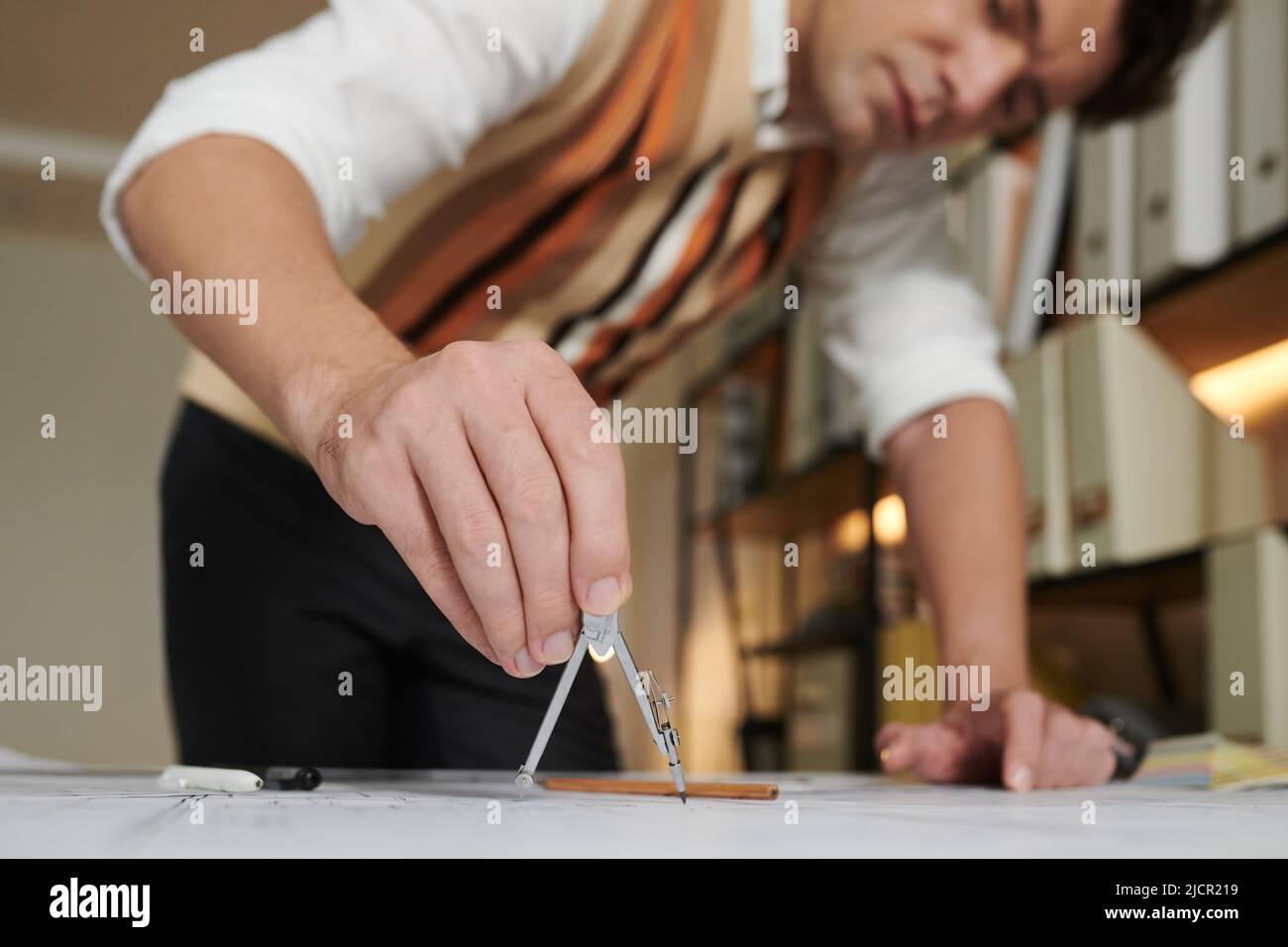 Civil engineer measuring distance between two dots on building ...