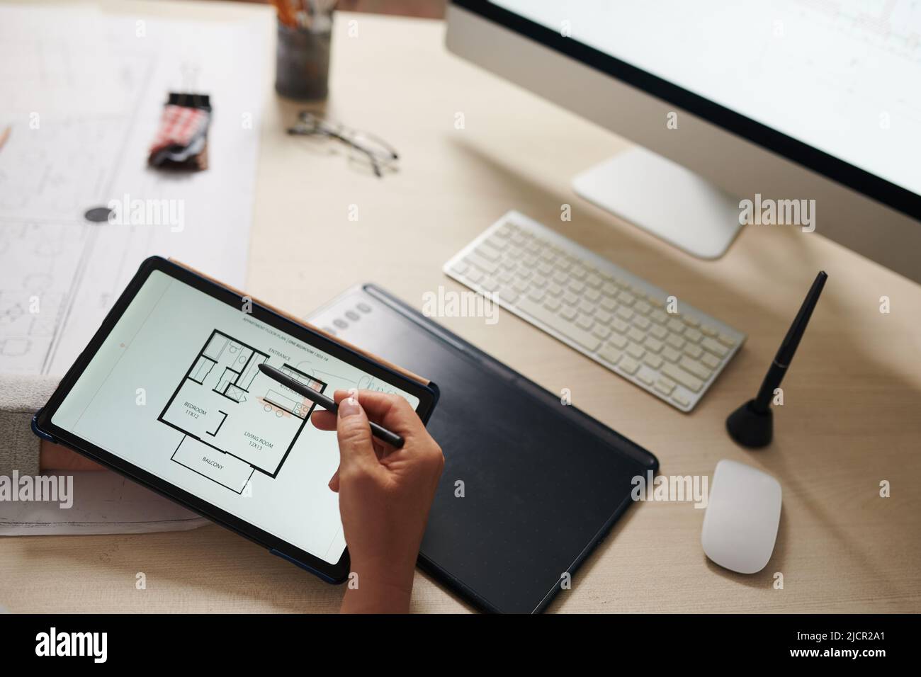 Closeup image of architect checking plan of house floor on tablet ...