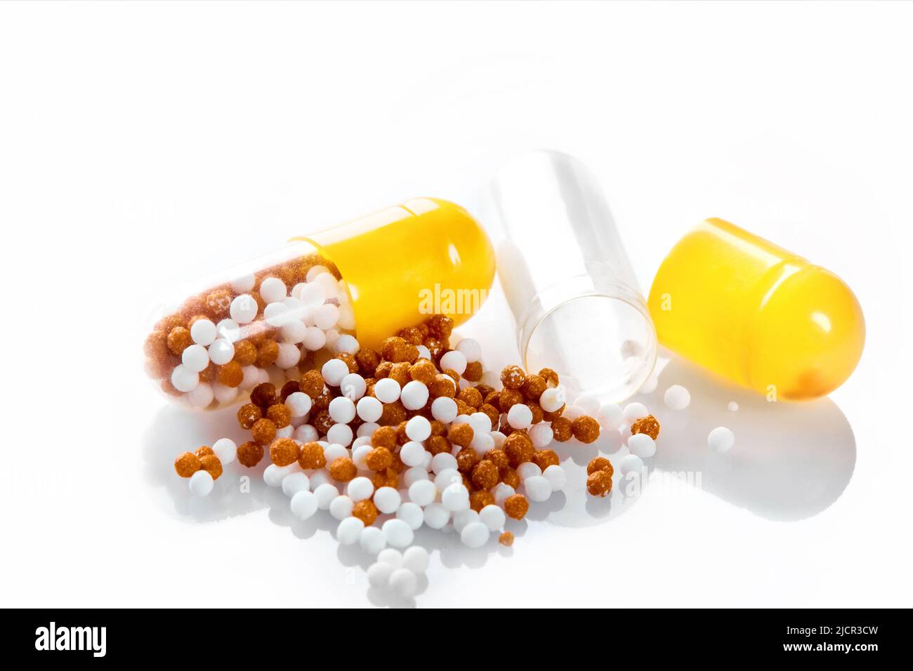 Macro yellow medical pill tablet with pellet, microgranules isolated on ...