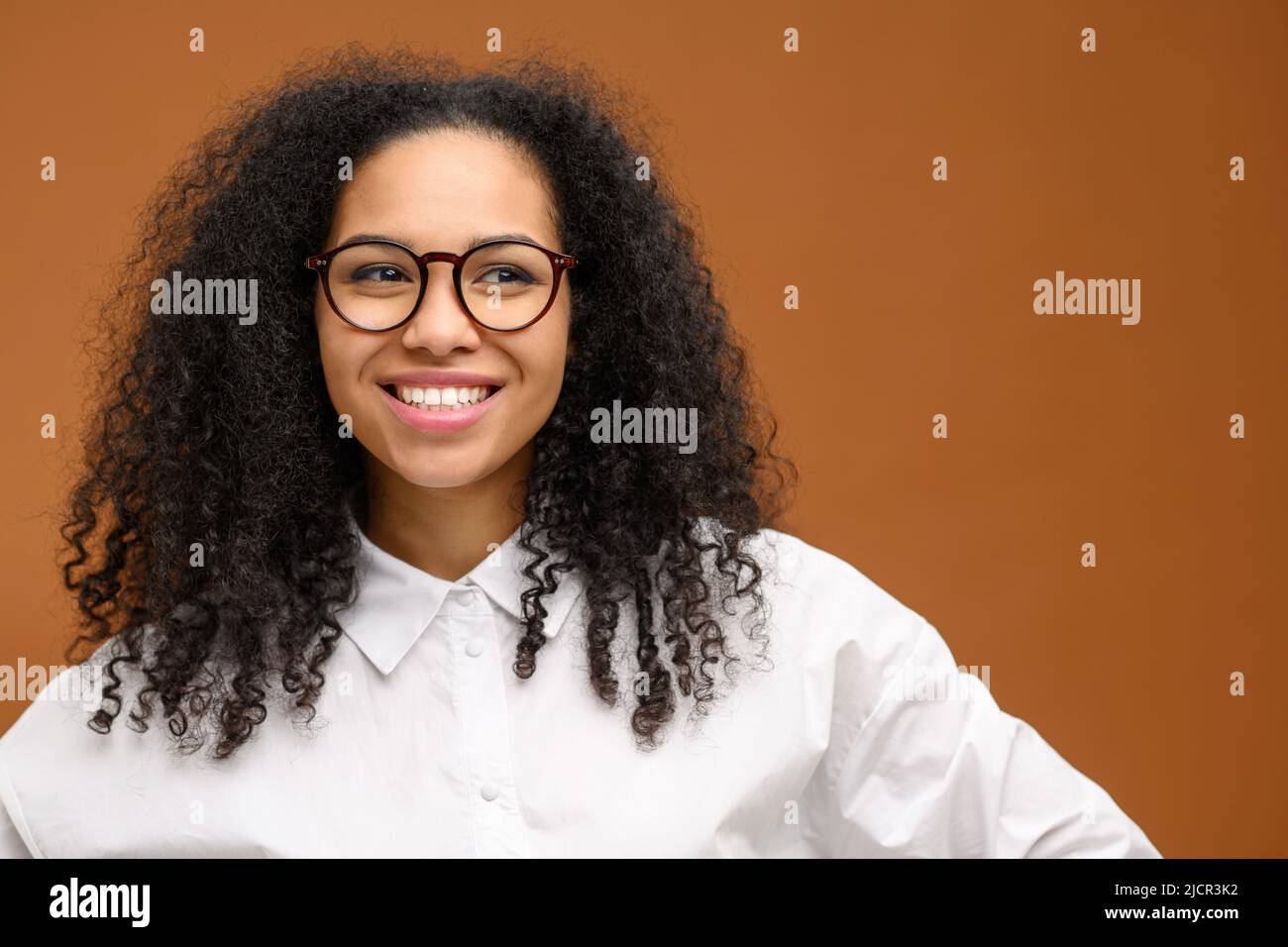 Cheerful female youngster isolated brown colour background. Young ...