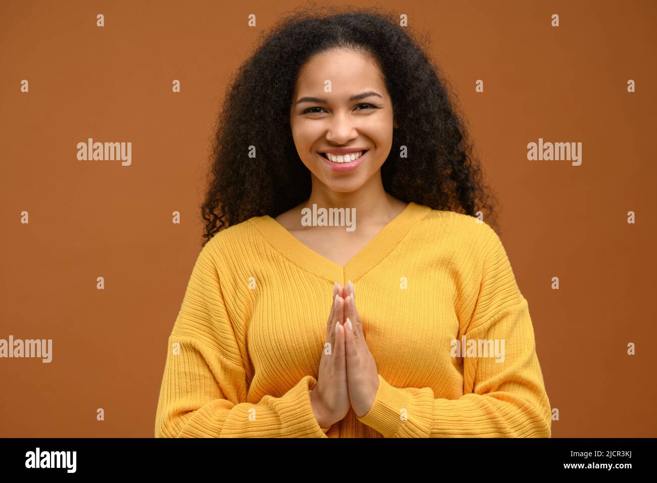 Beautiful multiracial woman thanking you, holding hands together in ...