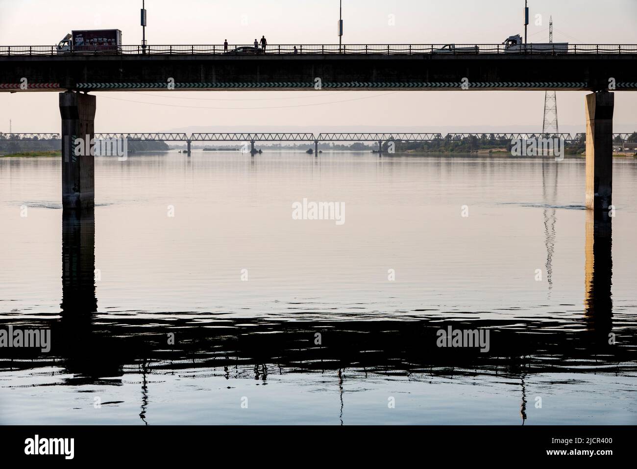 People standing and looking over the hand rail of a Bridge over the ...