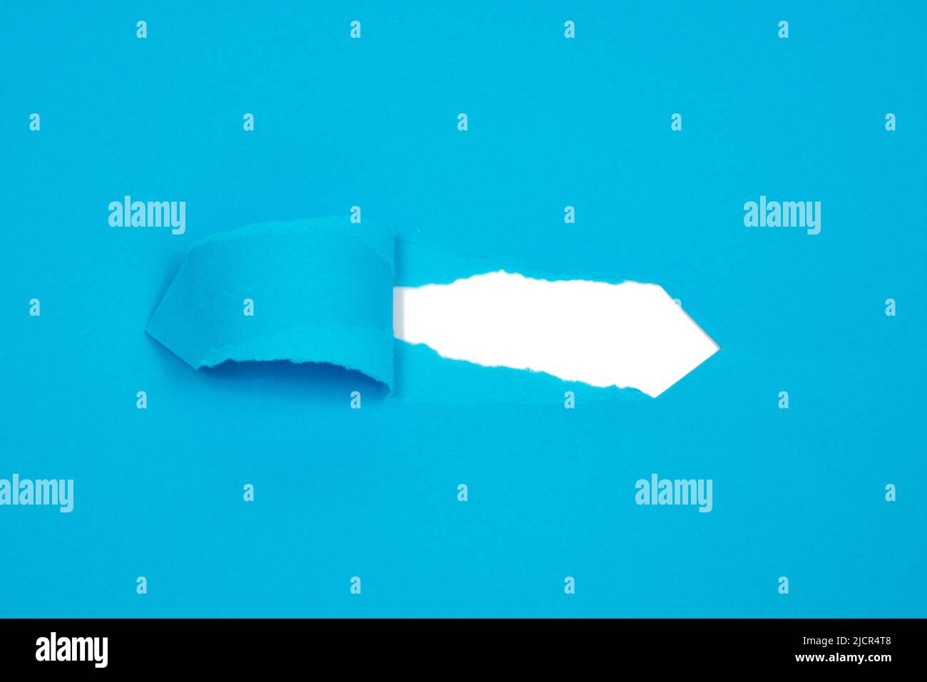 Hole in paper blue background torn damaged for design Stock Photo - Alamy