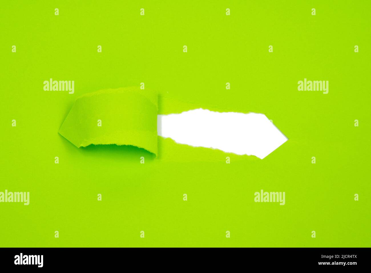 Hole in paper green background torn damaged for design Stock Photo - Alamy