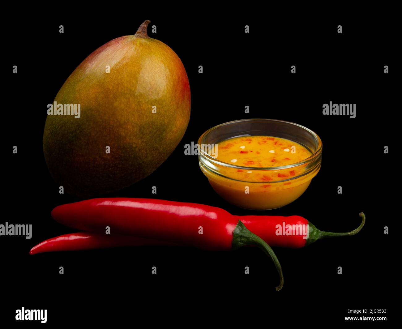 Mango, chili and mango chili sauce on black background. Side view Stock ...