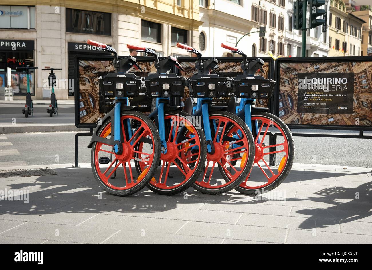 Rome, Italy - June 6, 2022: Four rental bicycles lined up with red rims ...