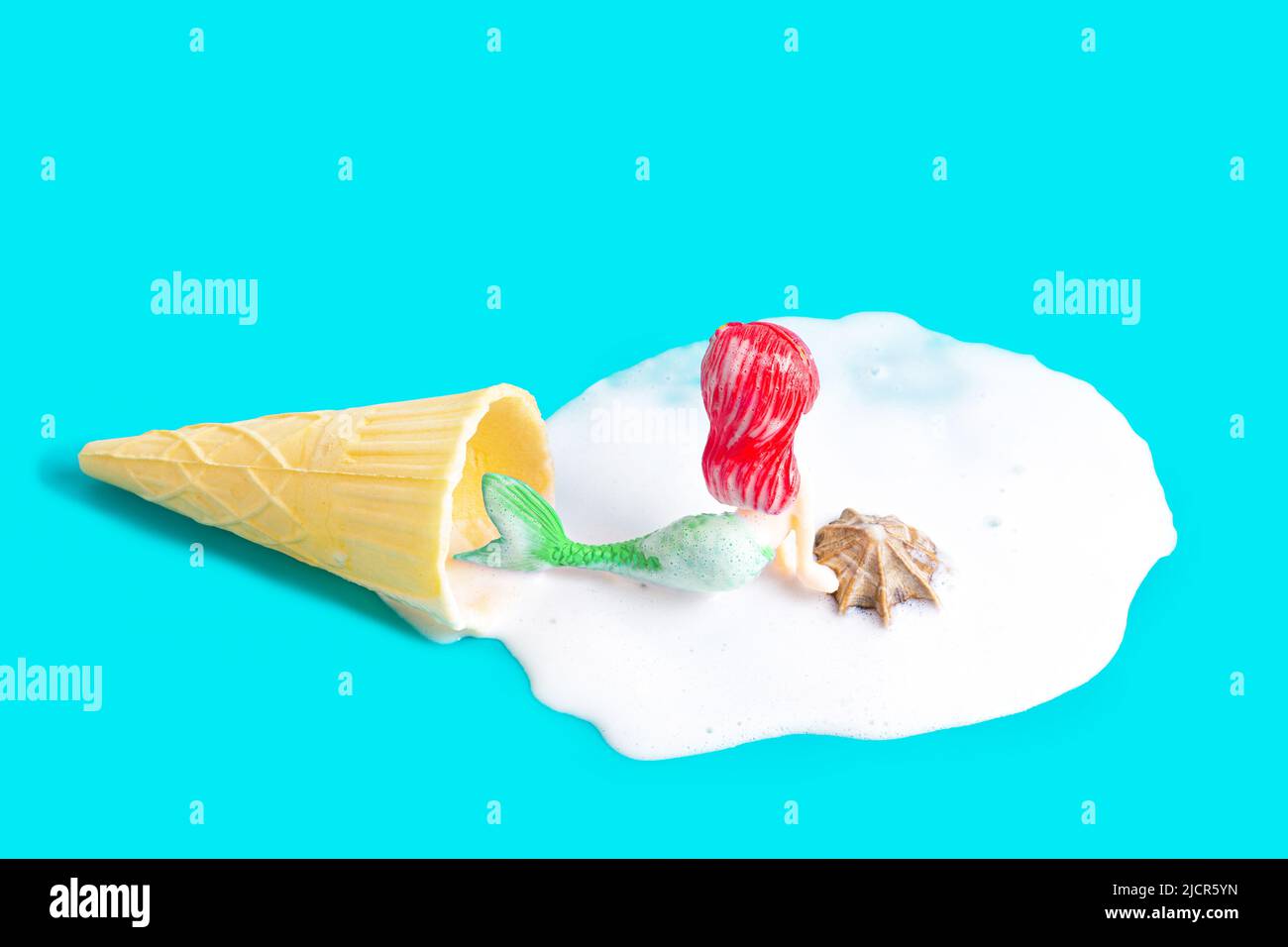 Mermaid figurine covered in sea foam made from melted ice cream on ...