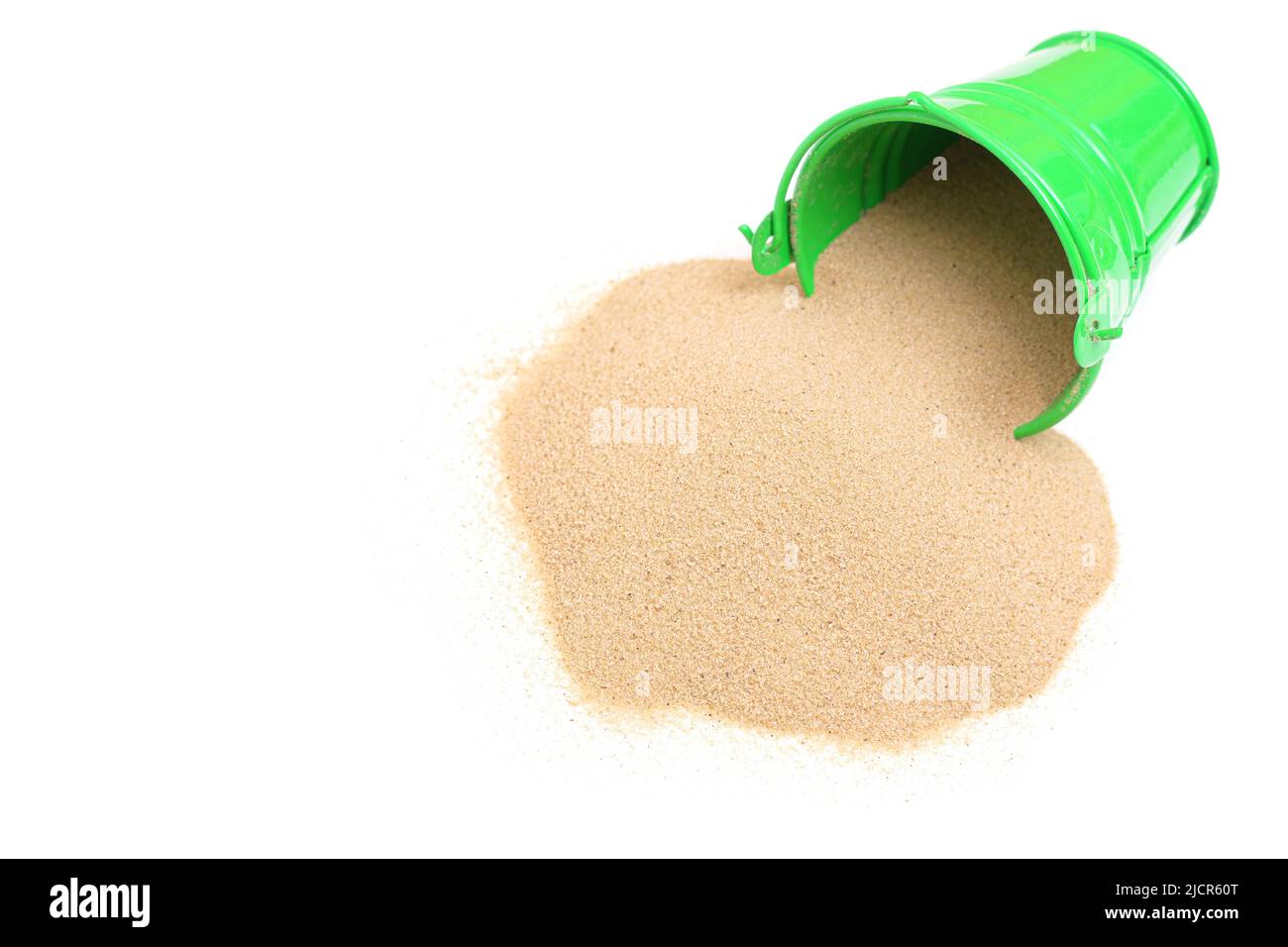 Overturned miniature steel bucket of sand isolated on white background ...