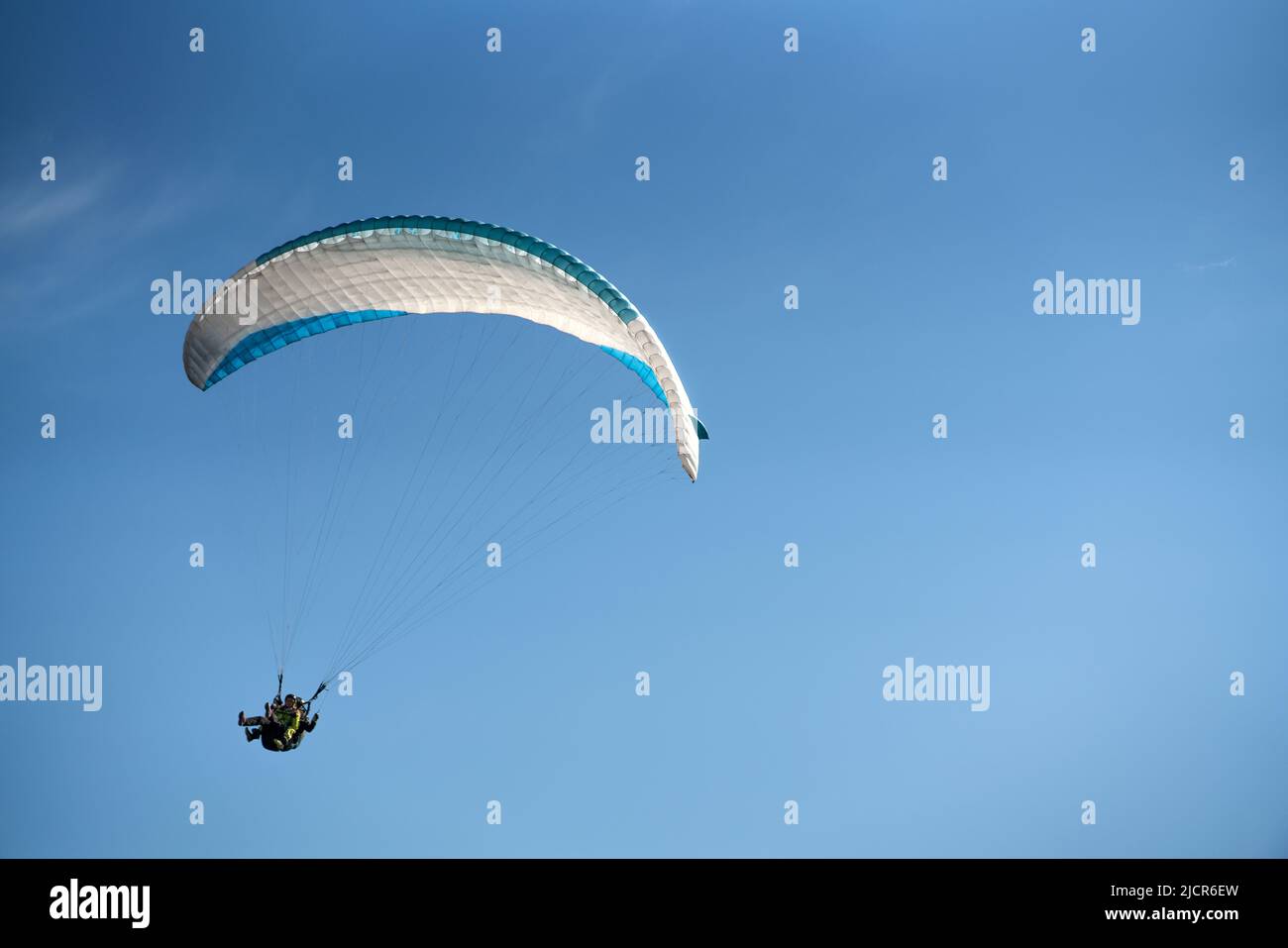 Paraglider in the blue sky. The sportsman flying on a paraglider Stock ...