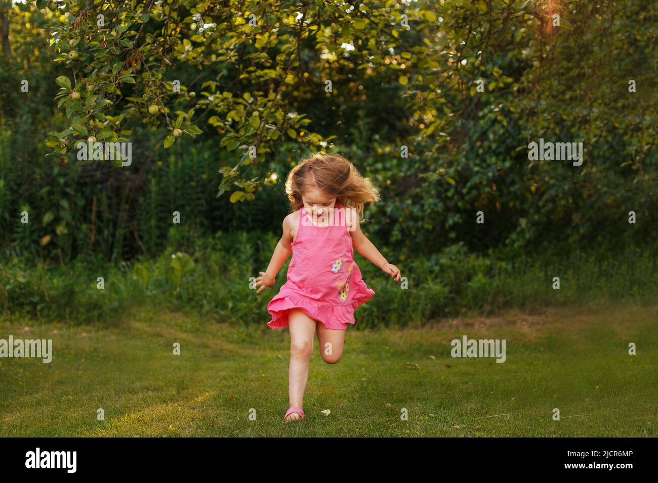 happy baby smiling. little girl running at sunset outdoor Stock Photo ...