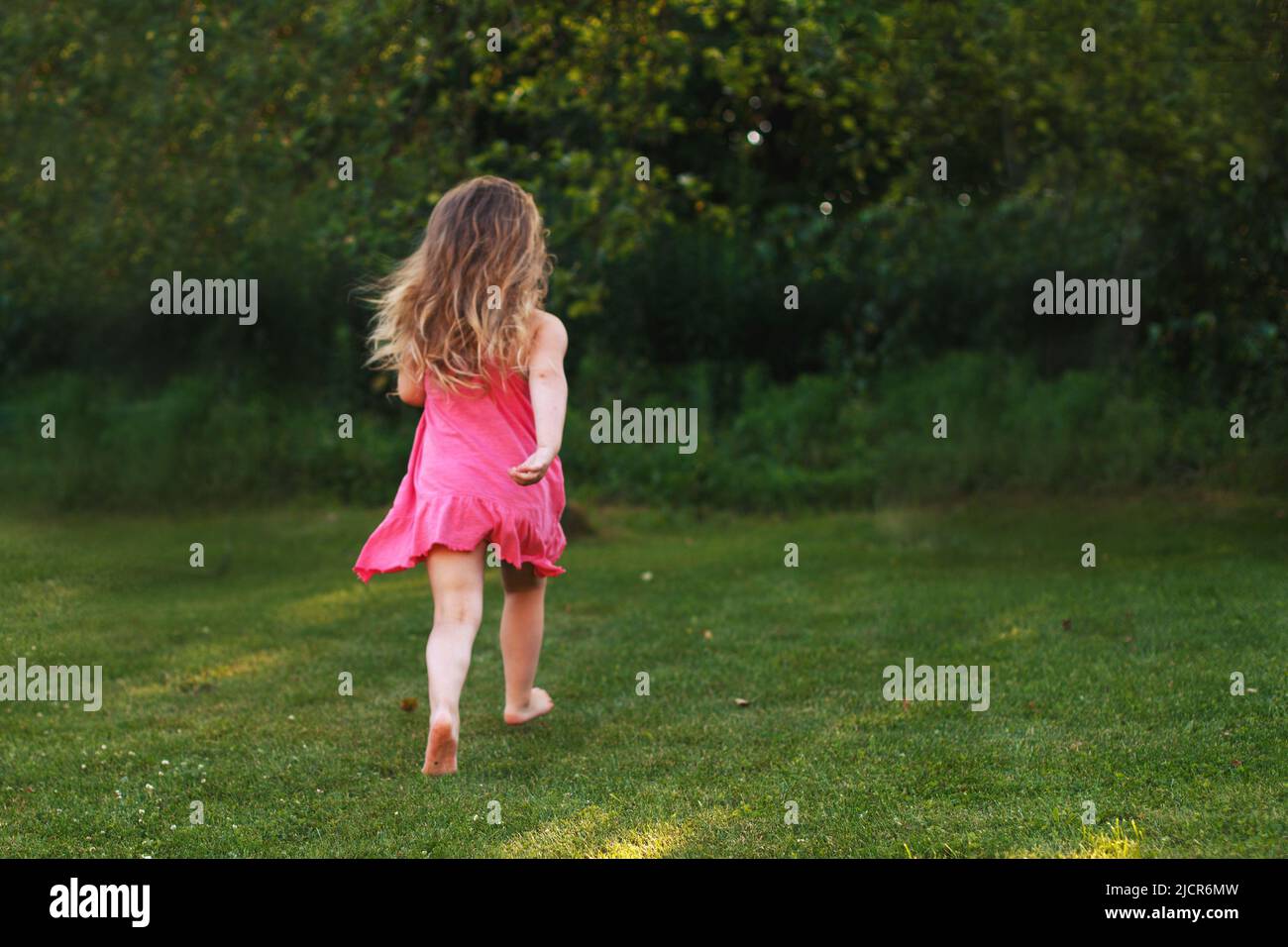 happy baby smiling. little girl running at sunset outdoor Stock Photo ...