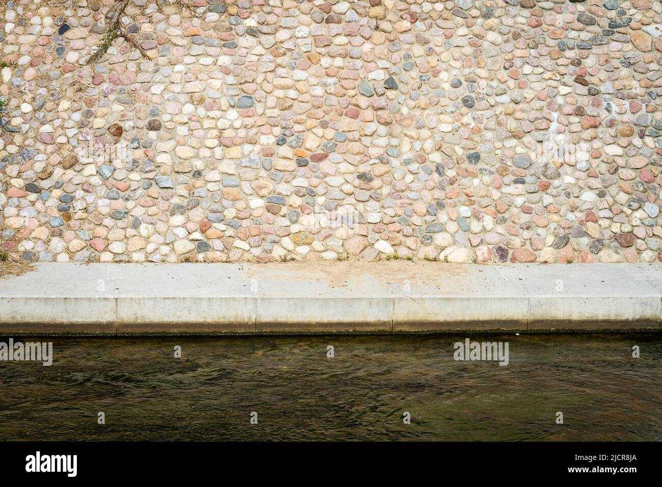 Stone and concrete retaining wall of the river bank Stock Photo - Alamy