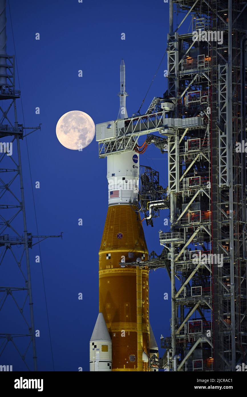 As NASA celebrates KSC's 60th Anniversary, a full moon sets behind NASA ...