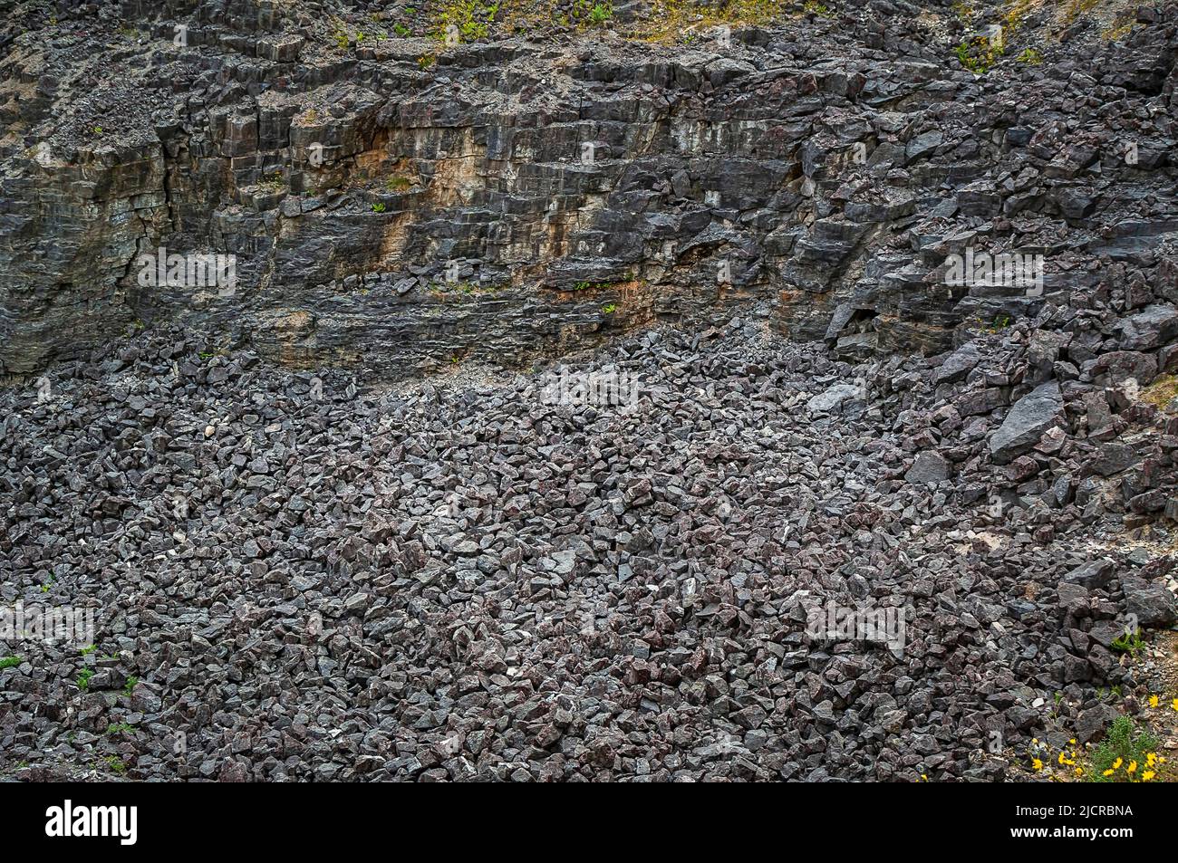 Piles of limestone boulders and shattered old working faces in an ...