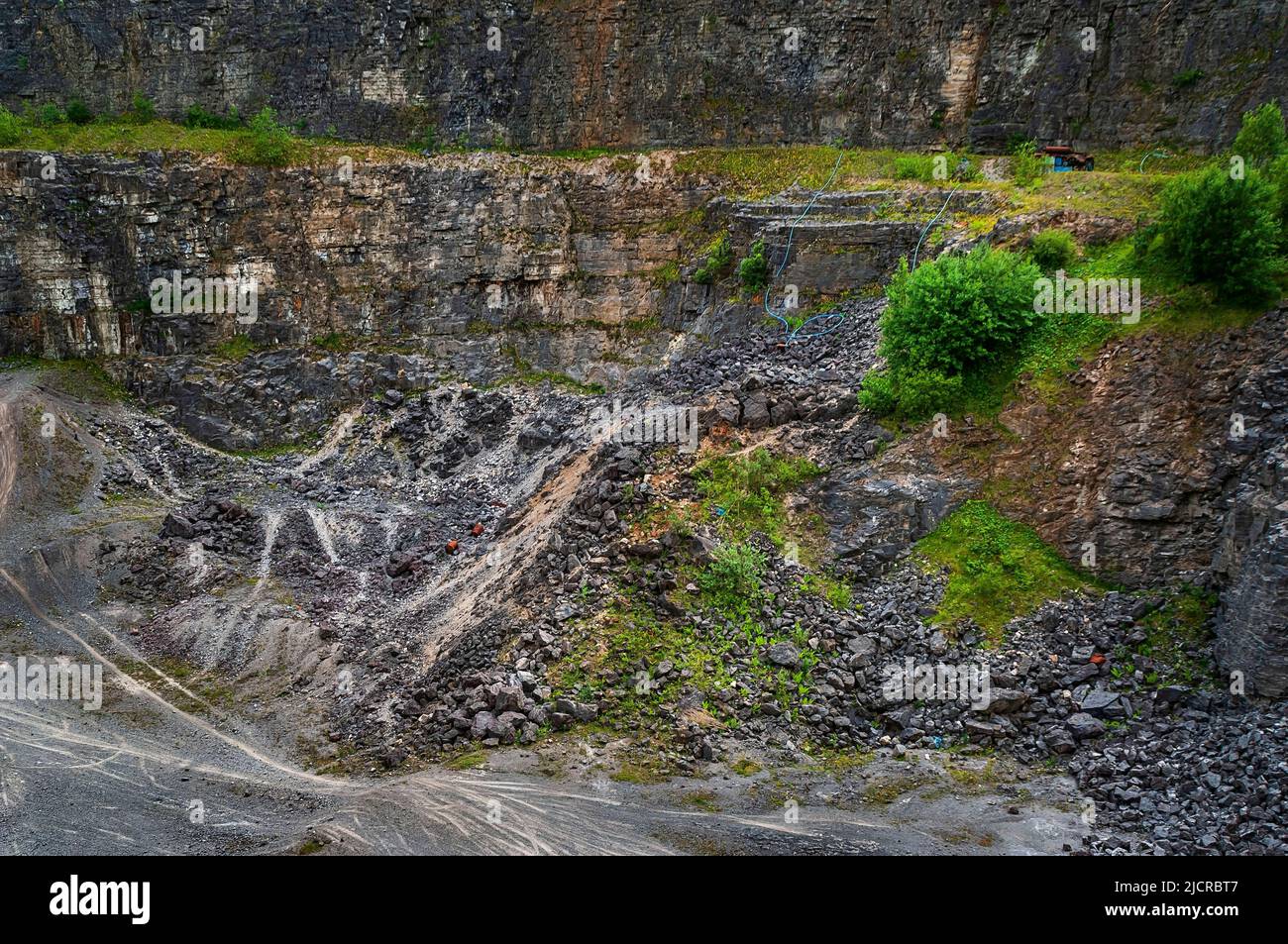 Piles of limestone boulders and shattered old working faces in an ...