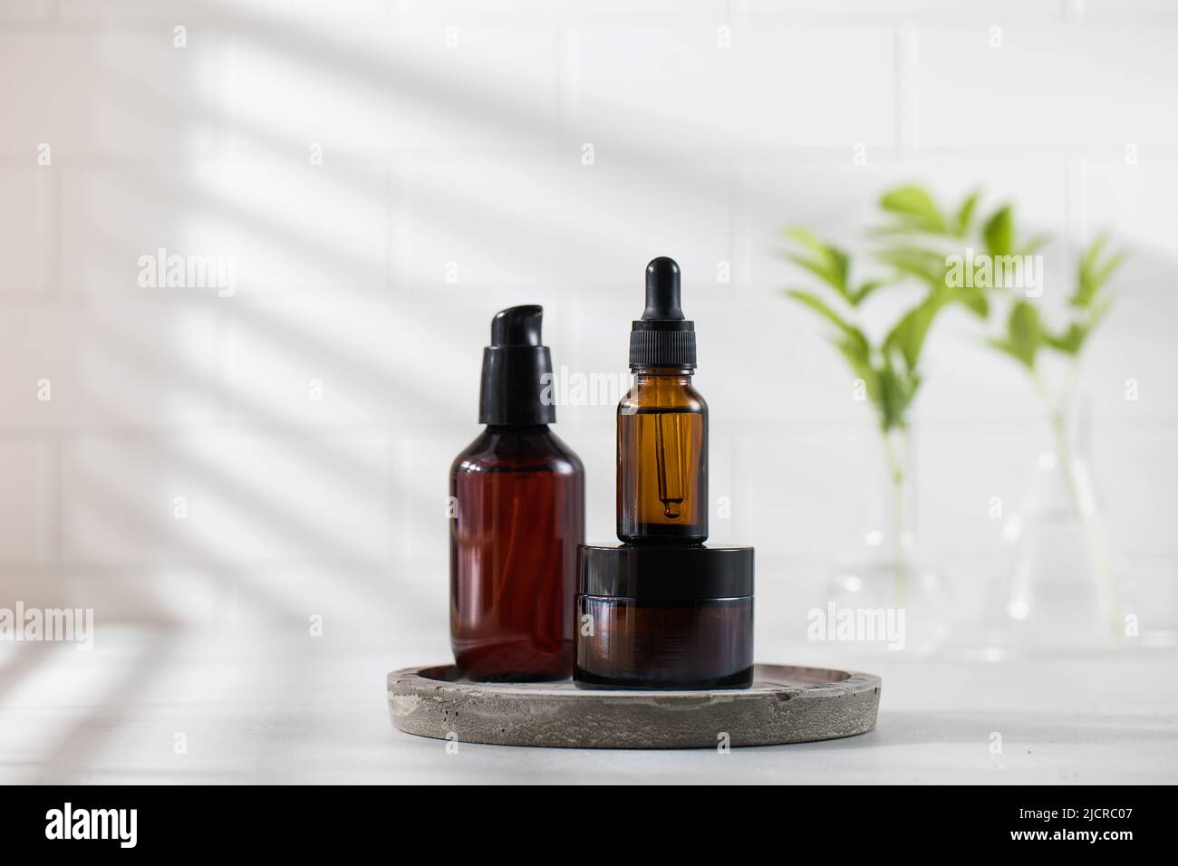 Three different brown glass bottles with eco-friendly organic cosmetic ...