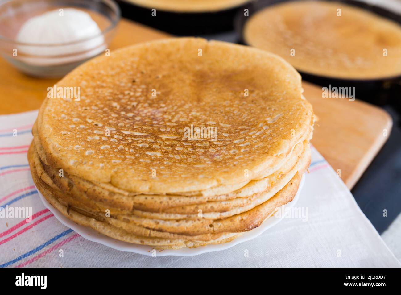 cooking traditional pancakes from wheat flour in the kitchen Stock ...
