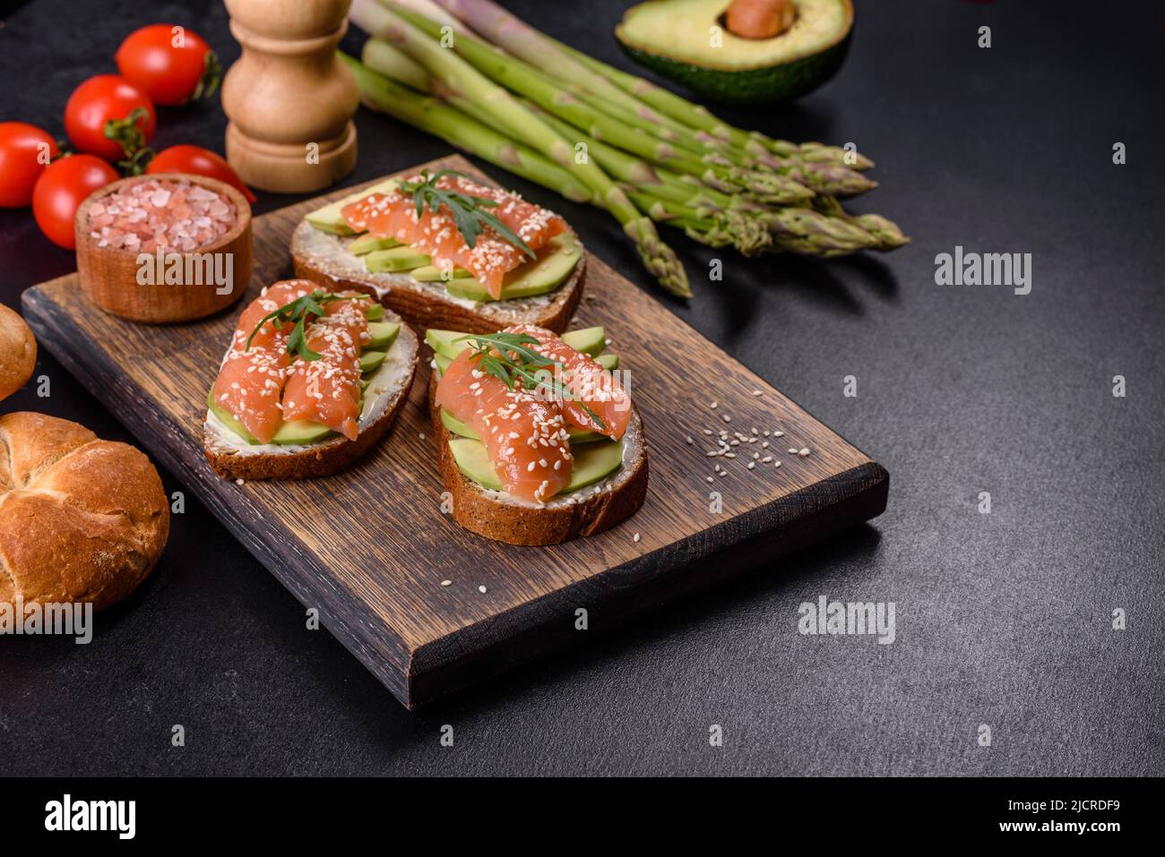 Open sandwich or toast. Grain bread with salmon, avocado and sesame ...