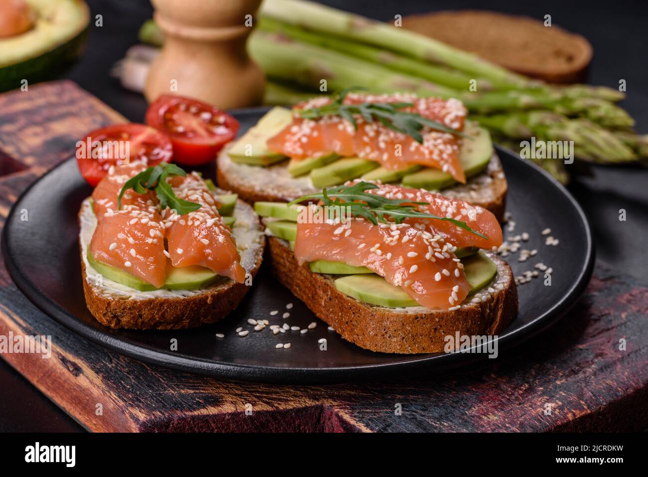 Open sandwich or toast. Grain bread with salmon, avocado and sesame ...