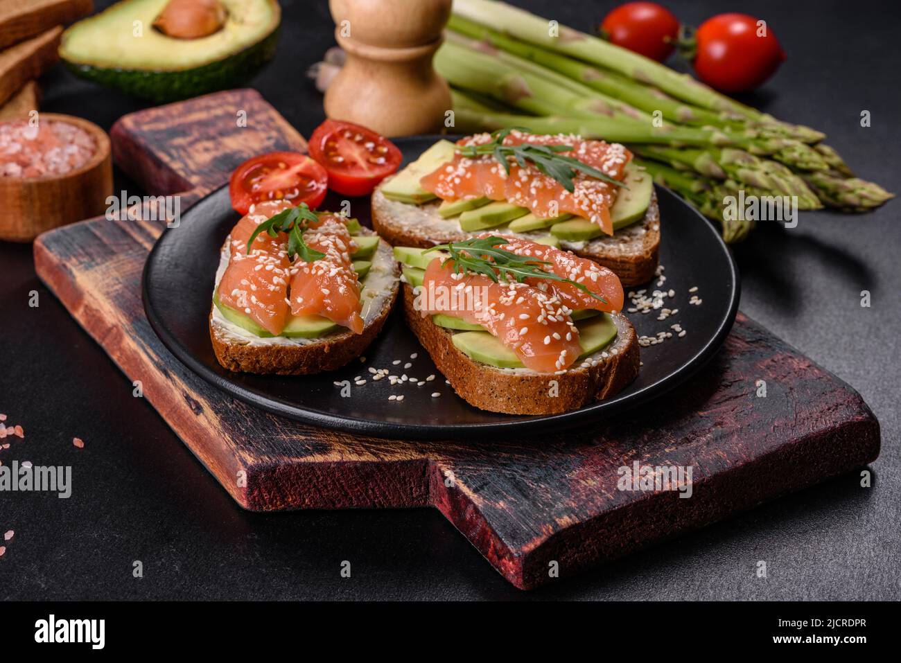 Open sandwich or toast. Grain bread with salmon, avocado and sesame ...