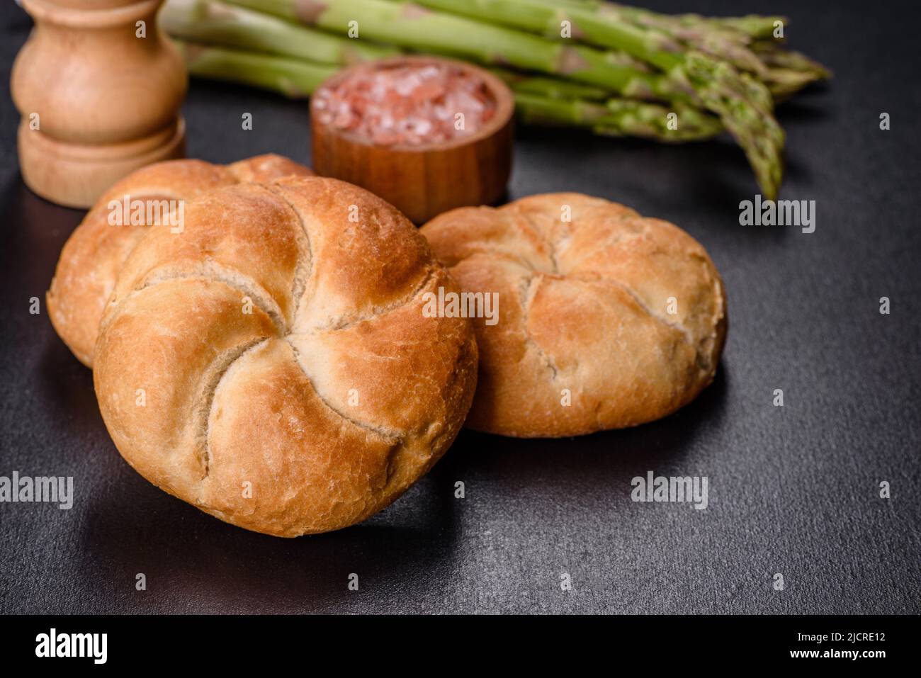 Crusty round bread rolls, known as Kaiser or Vienna rolls on a cutting ...