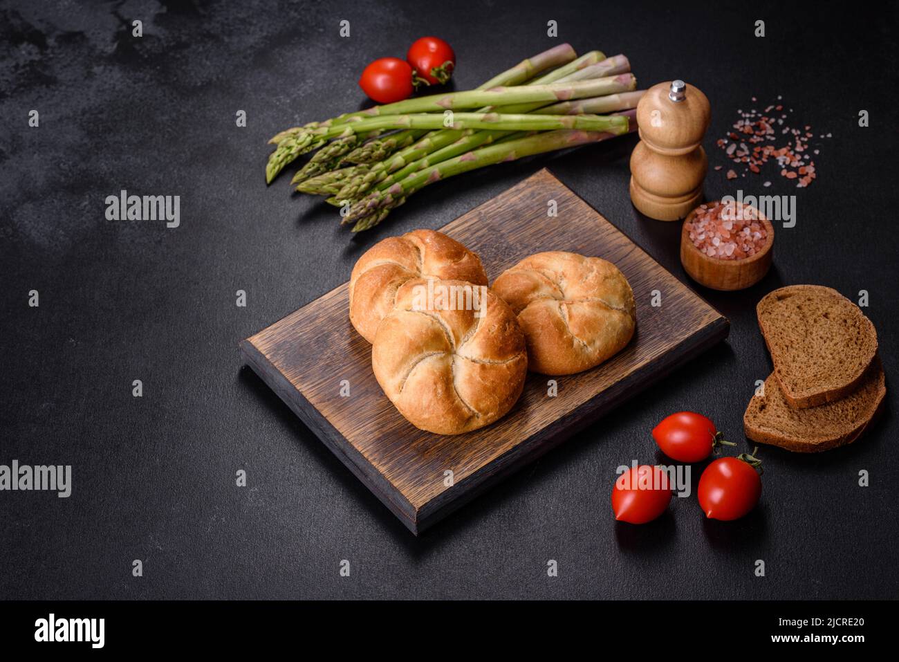 Crusty round bread rolls, known as Kaiser or Vienna rolls on a cutting ...