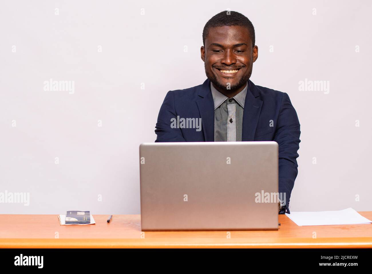 portrait of an african businessman smiling while working Stock Photo ...