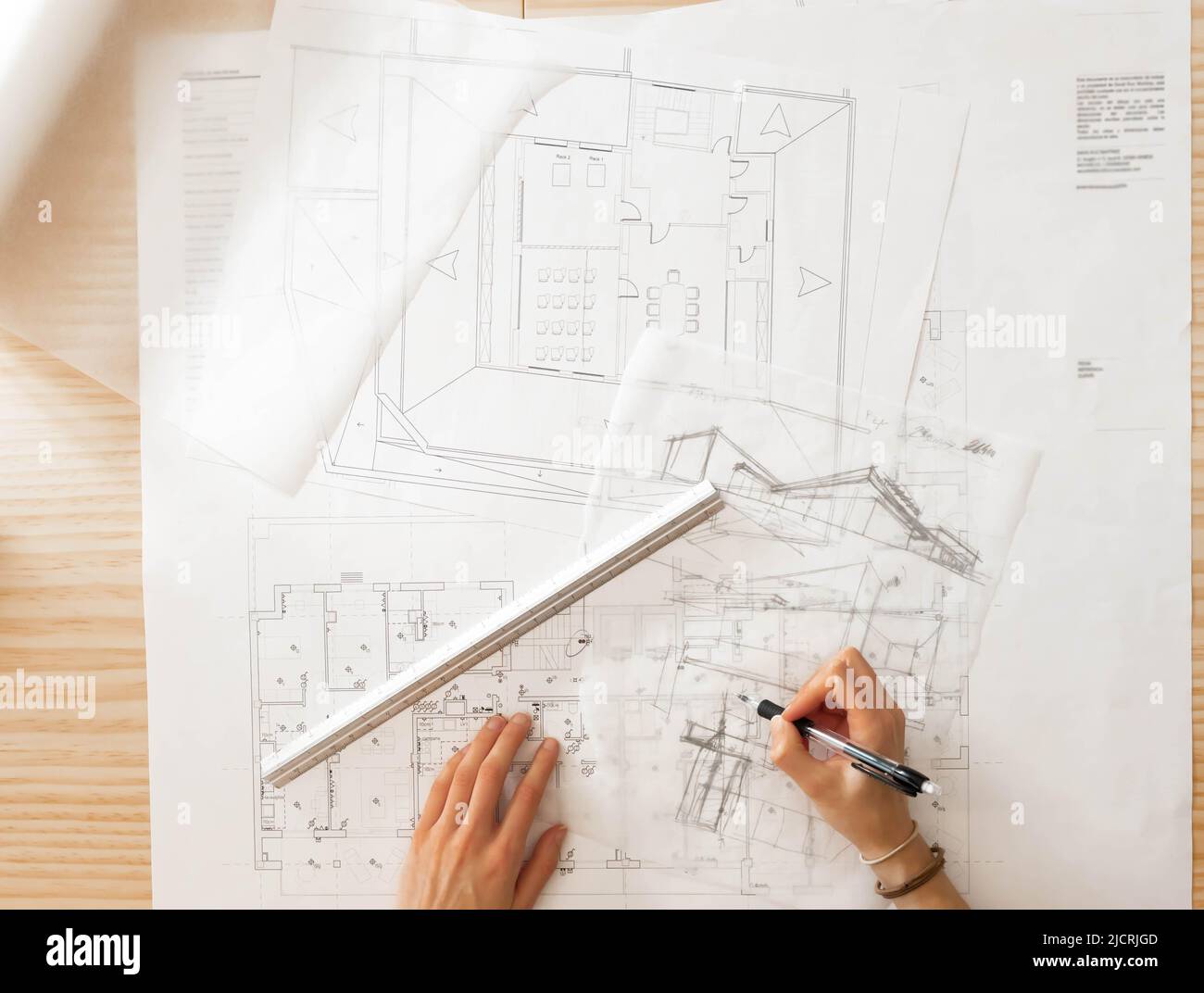 Hands drawing sketches and designing architectural blueprints with ...