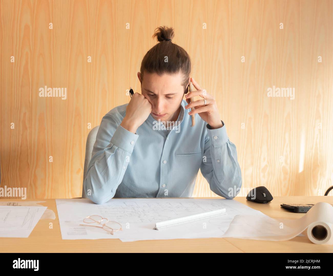 Man working in office pensative about interior design project while ...