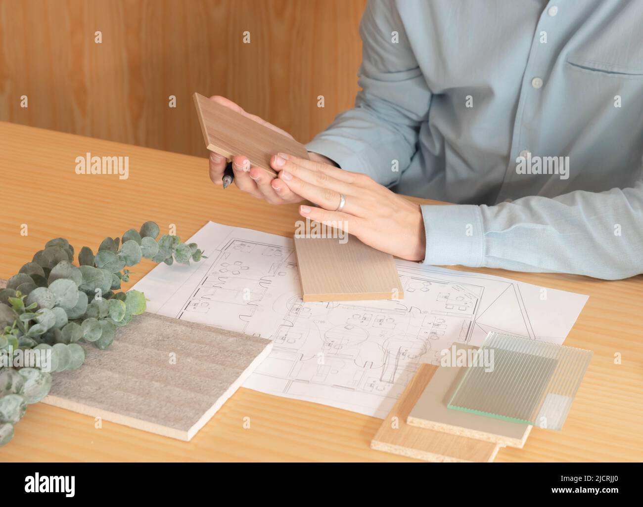 Achitect worinking on interior design picking up different samples of ...