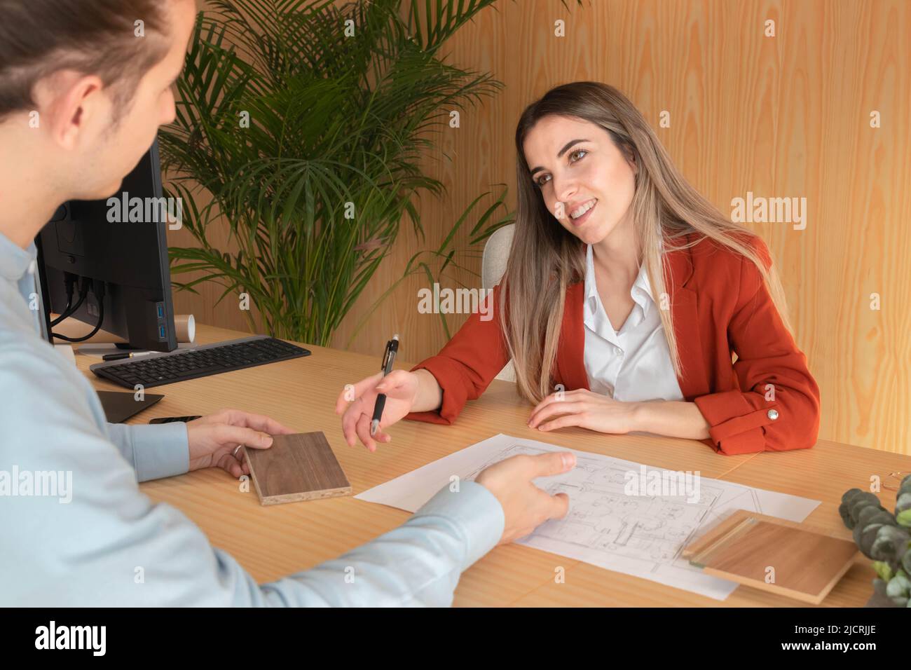 Interior designer discussing the project with the customer and choosing ...