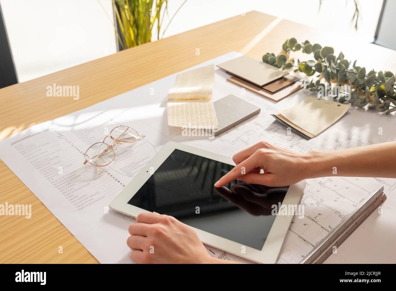 Woman touching tablet touch screen with background interior design ...