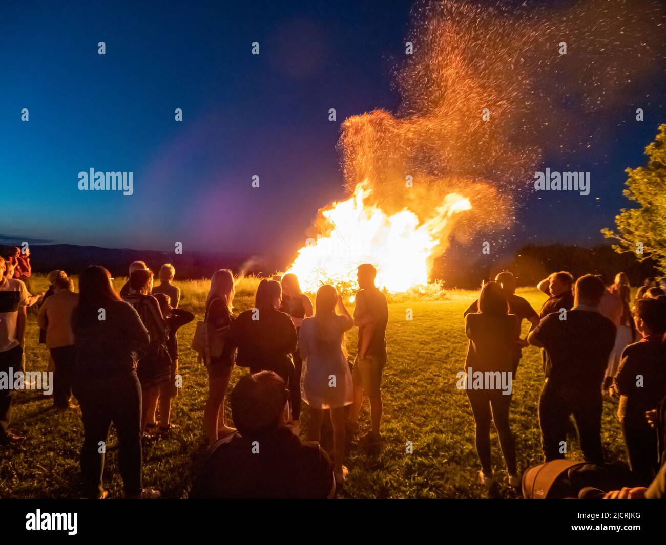 A group of people watch the festive bonfire. Bavaria is a part of ...