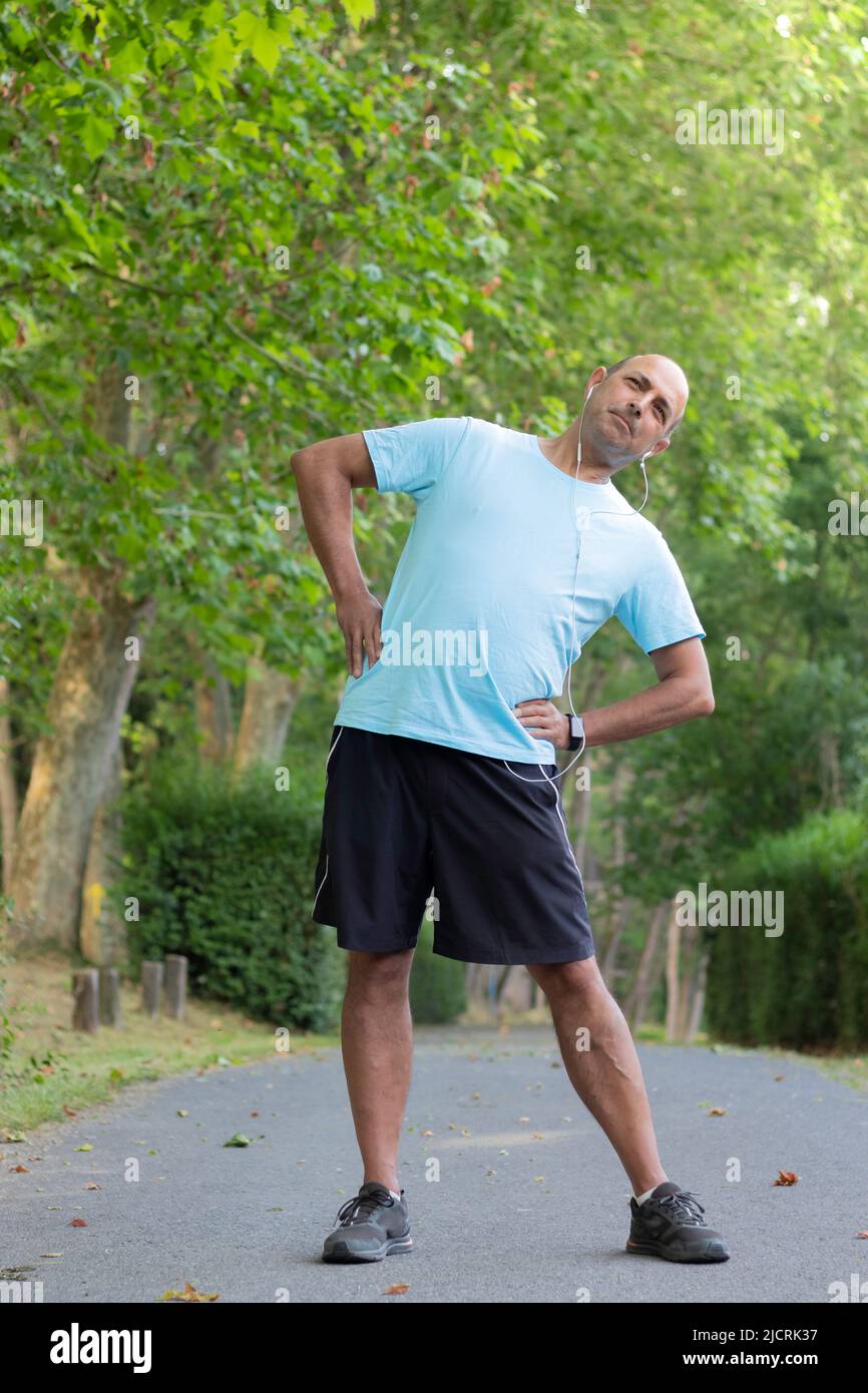 Full body bottom picture of an adult man stretching and exercising on a ...