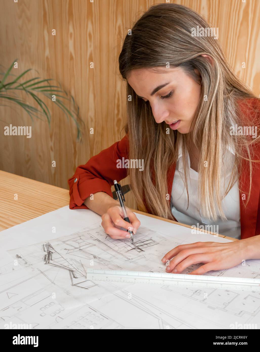 Front view portrait of woman architect drawing sketches in studio Stock ...