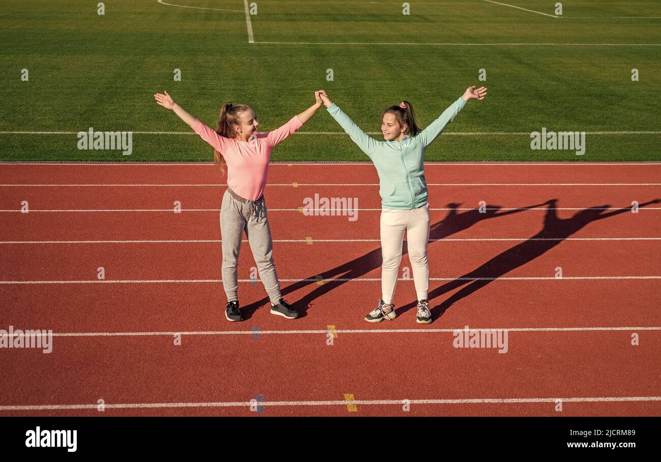 Sports really strengthen friendship. Happy friends hold hands on ...