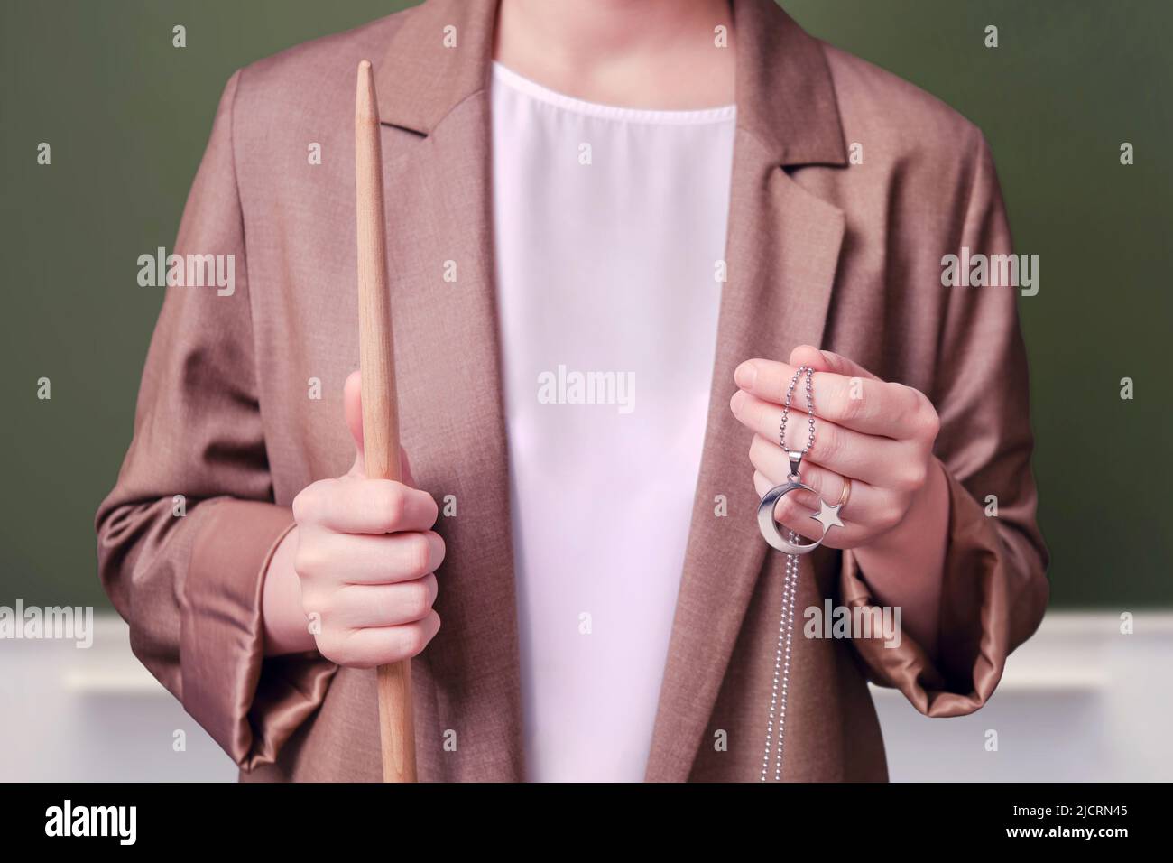 Woman teacher holding muslim crescent moon religious symbol on school ...