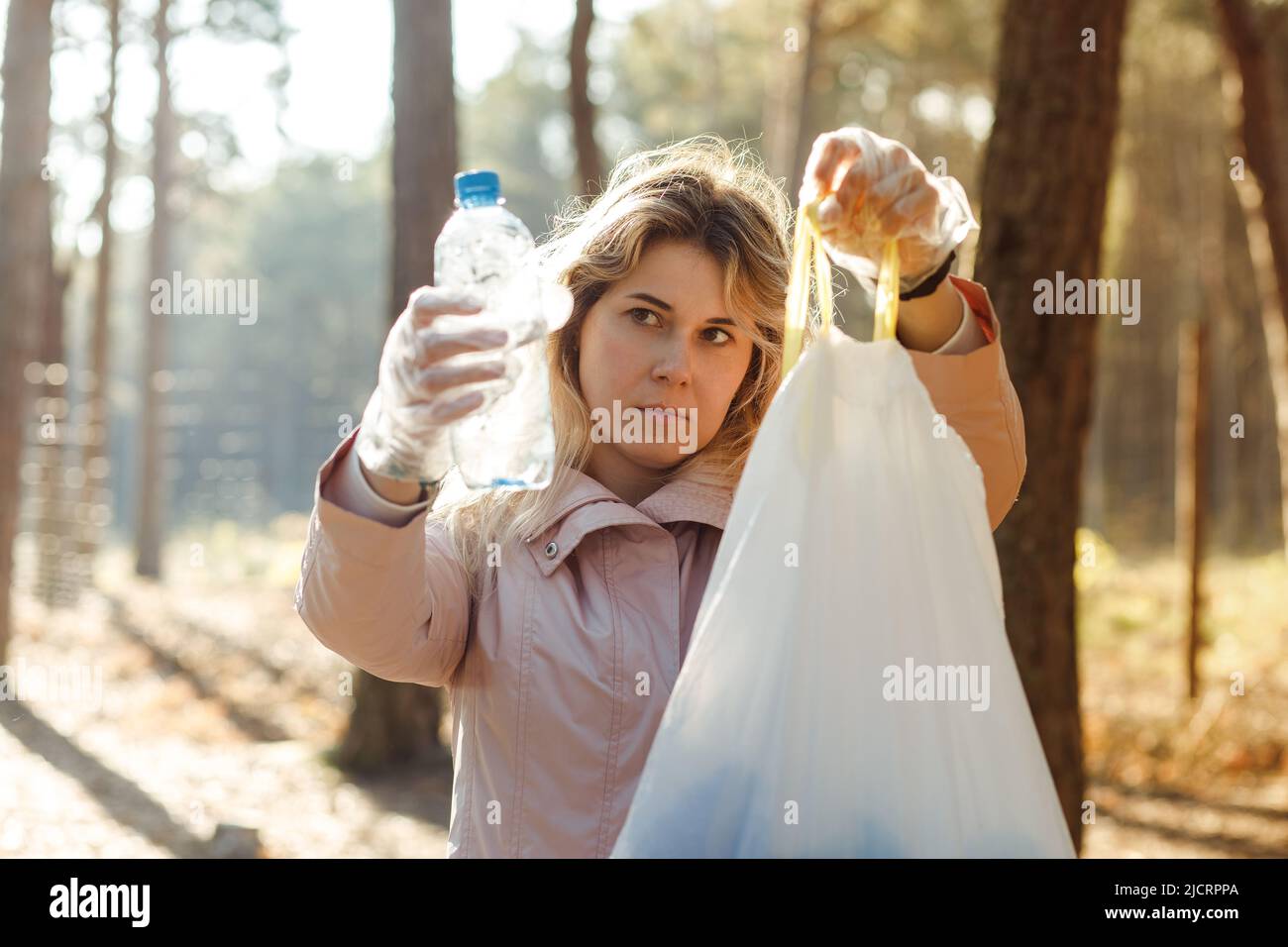 Sad, disappointed woman, volunteer and assistant clean forest from ...